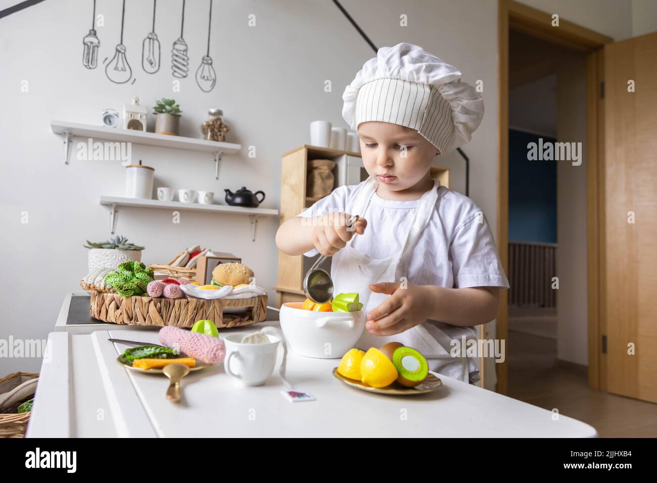 Cute baby boy chef uniform cooking playthings vegetable salad at ...