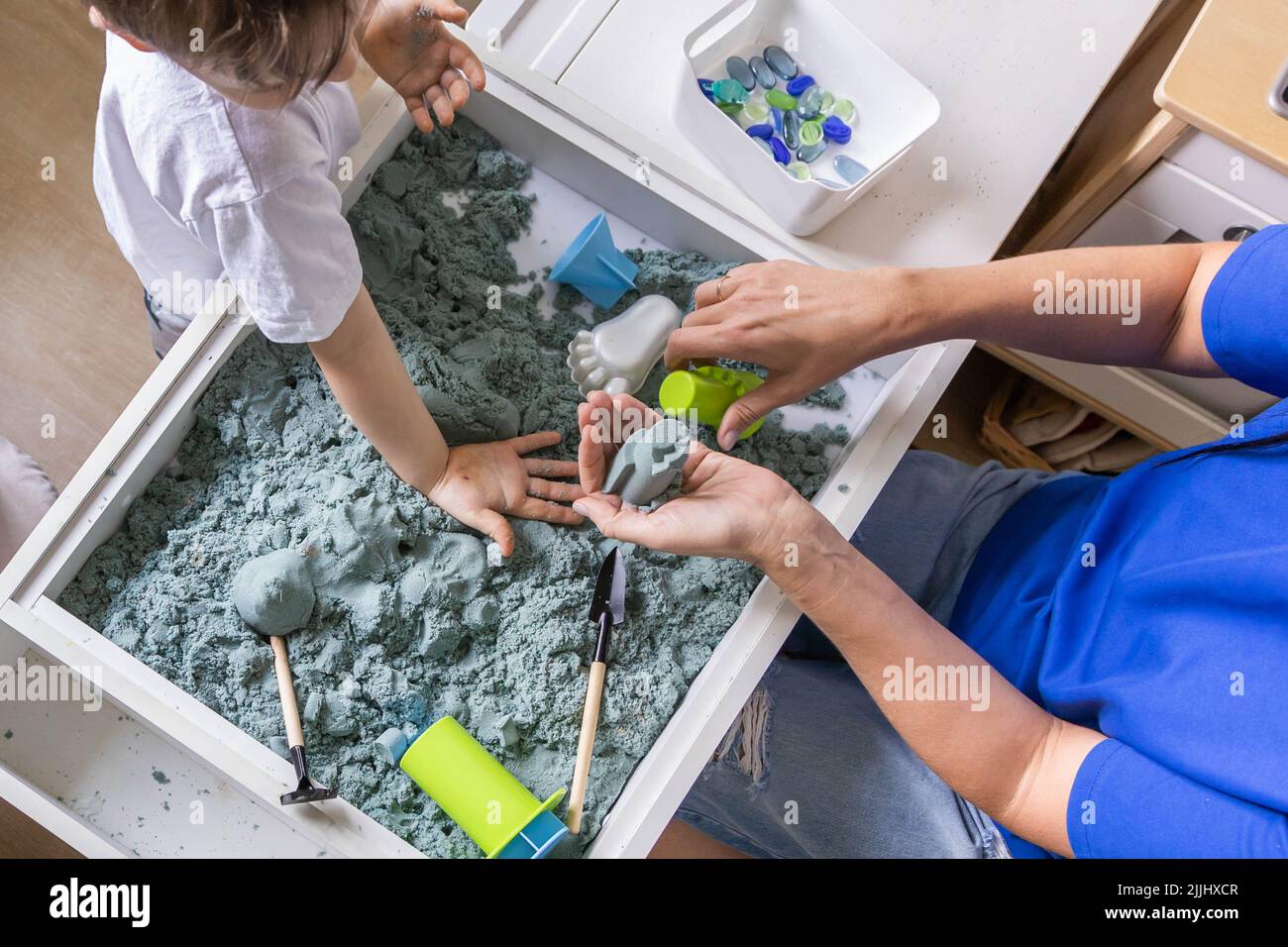 Cute male kid son and mother playing kinetic sand form early ...