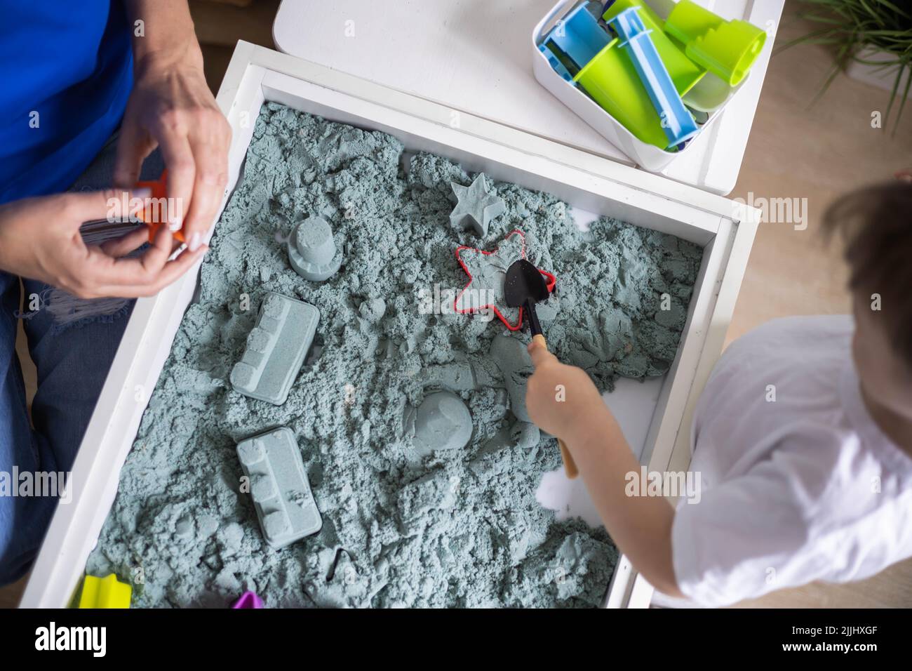 Cute male kid son and mother playing kinetic sand form early ...