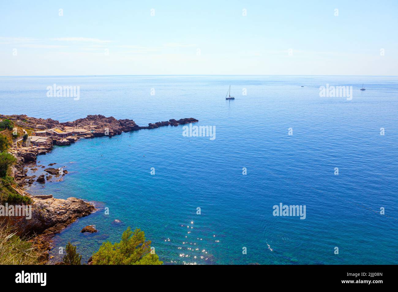 Calm sea and rocky beach . Blue lagoon with turquoise water Stock Photo ...
