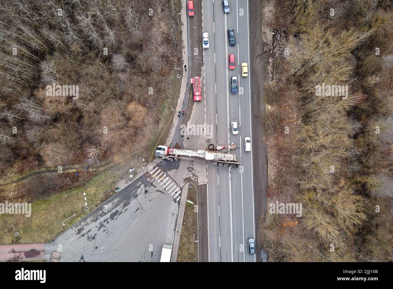 Aerial view of road accident with overturned truck blocking traffic ...
