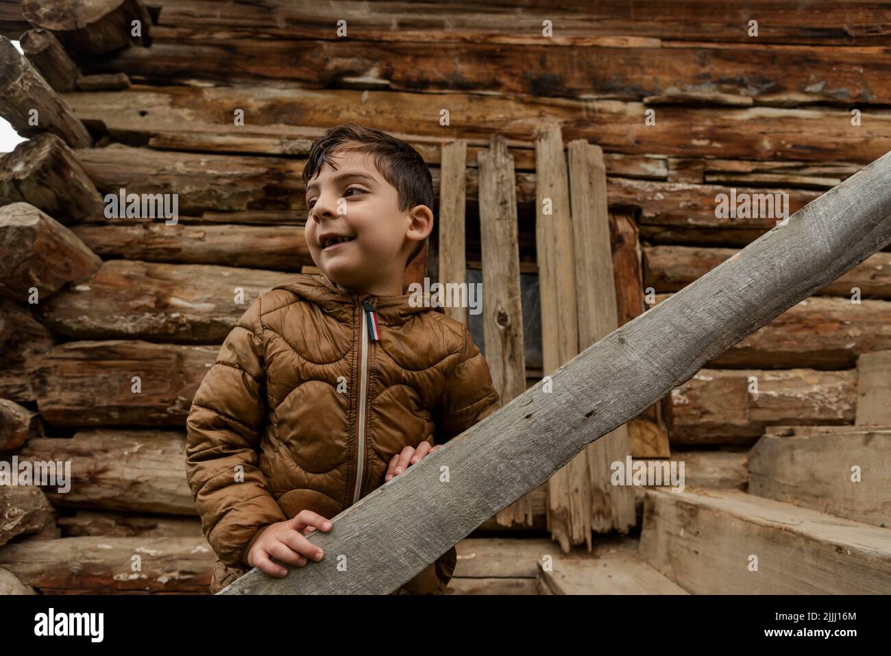 A boy poses for a picture outside his wooden house in Gurez. (Photo by ...