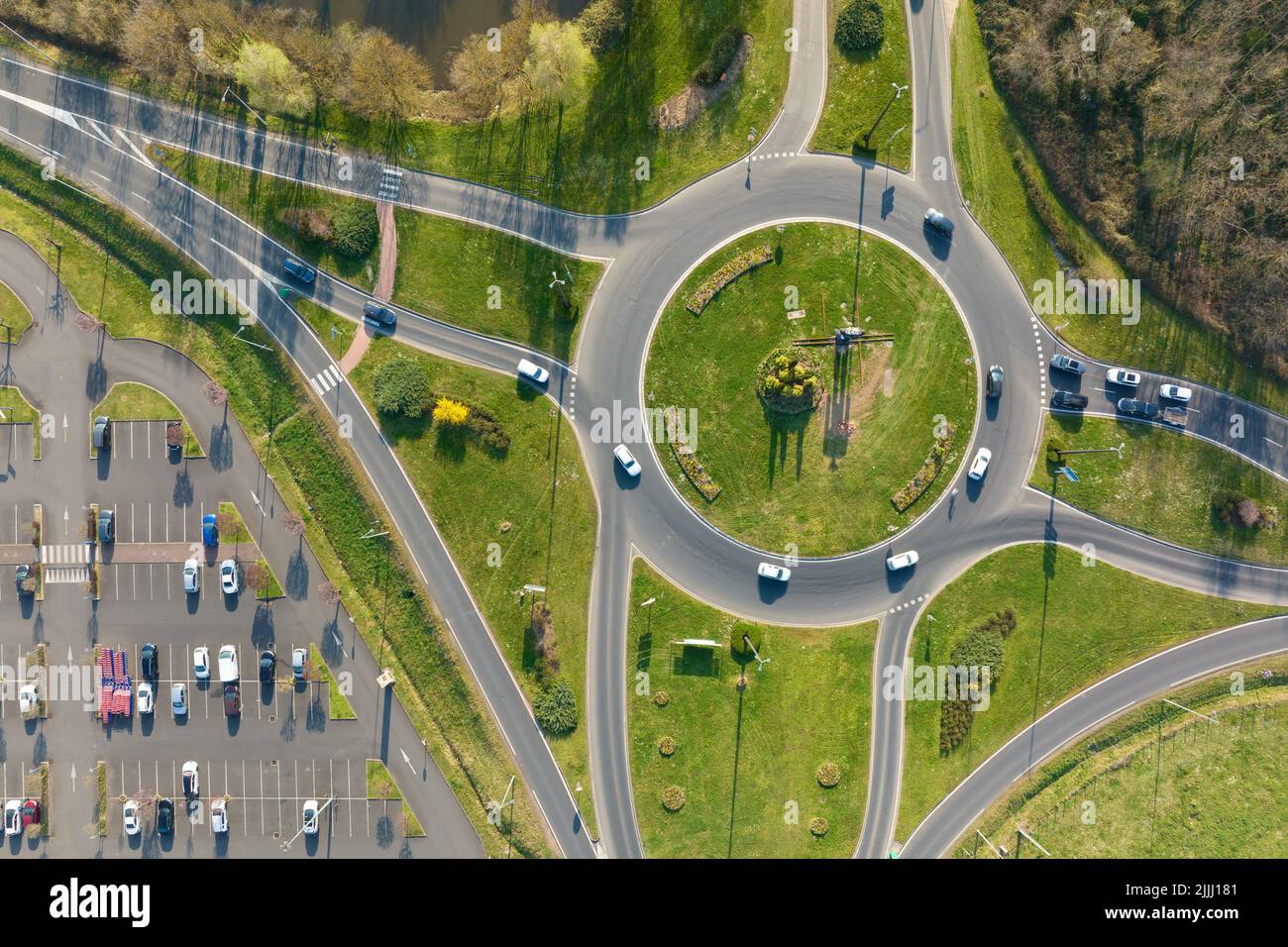 Aerial view of road roundabout intersection with moving heavy traffic ...
