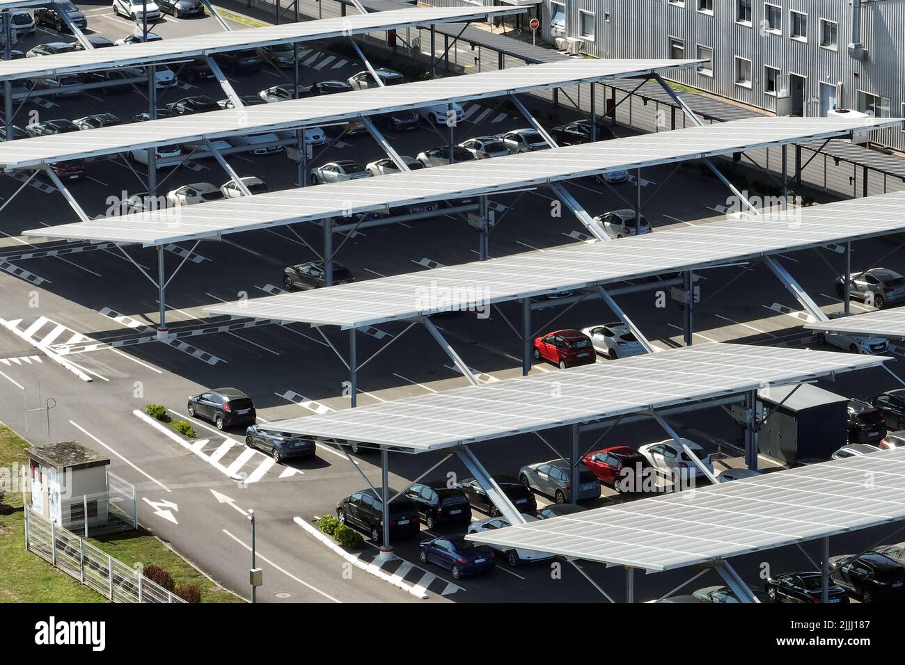 Aerial view of solar panels installed over parking lot with parked cars ...