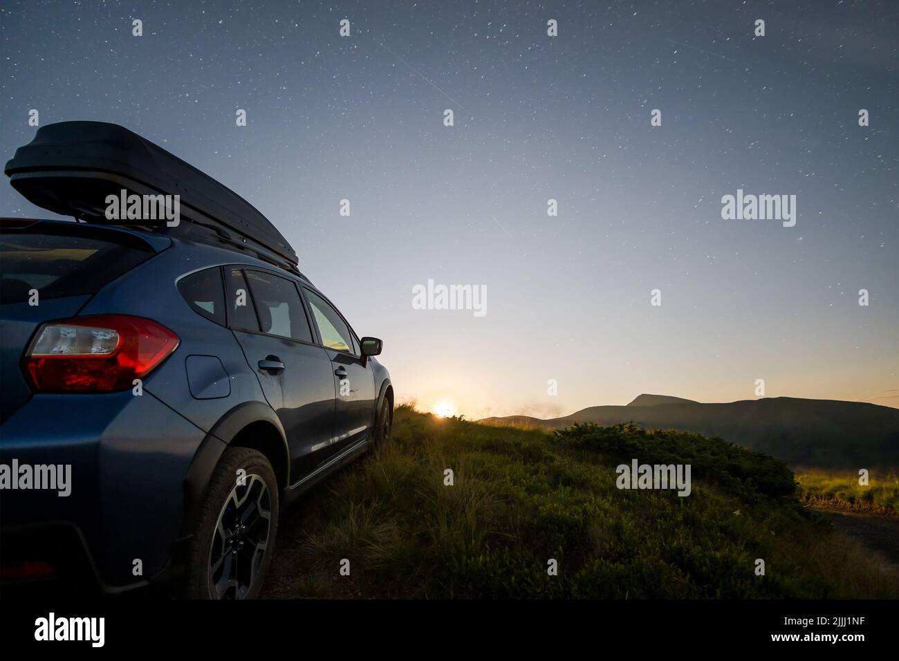 Blue offroad SUV car with roof trunk on background of very beautiful ...