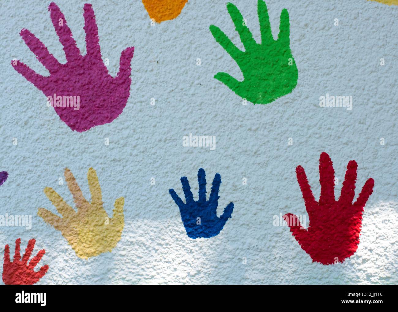 Multicolored handprints on white background. Top view Stock Photo - Alamy