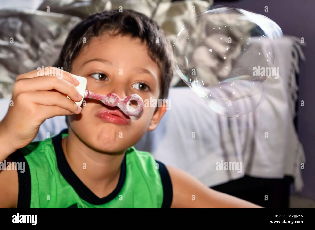 Portrait of a child blowing soap bubbles. Salvador, Bahia, Brazil Stock Photo - Alamy