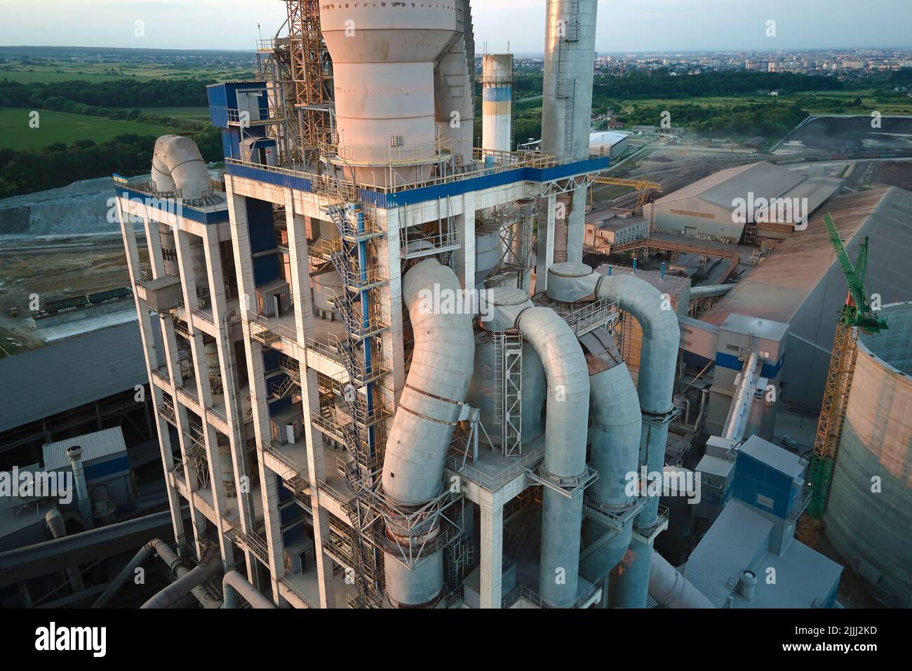 Cement plant with high factory structure and tower cranes at industrial ...