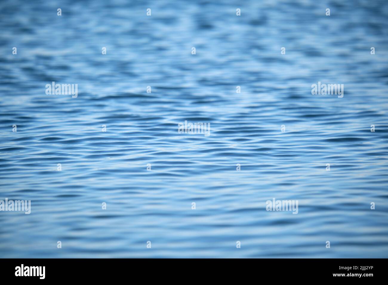Closeup seascape surface of blue sea water with small ripple waves ...