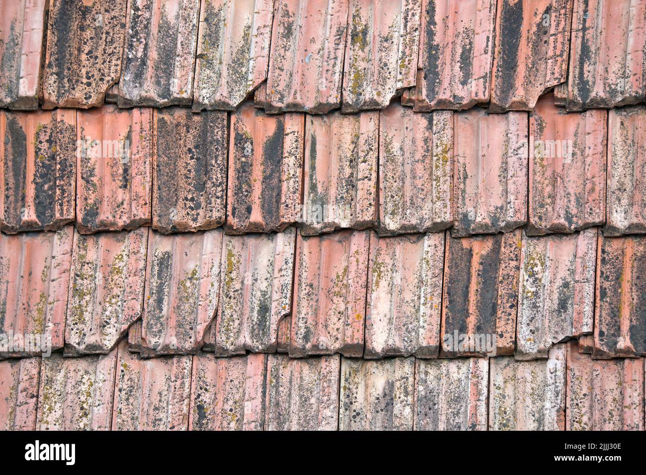 Closeup surface of old weathered ceramic tiles covering building roof ...