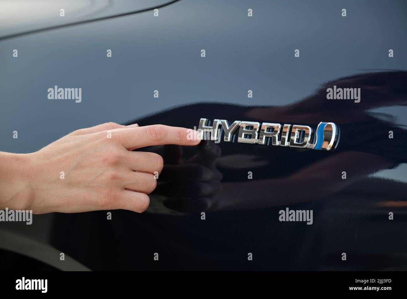 Human hand showing hybrid car sign on new effective vehicle Stock Photo ...