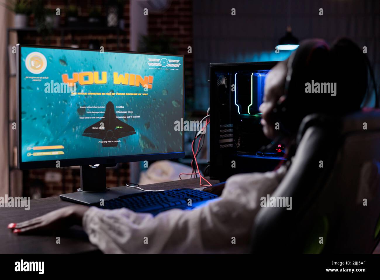 Young gamer celebrating successful video games online win, using ...