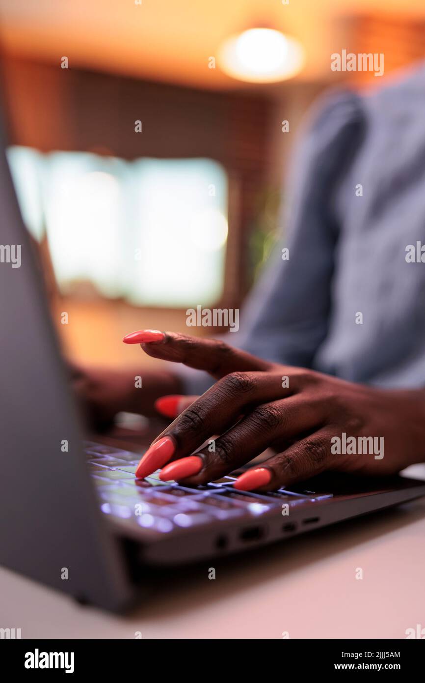Young african american female freelancer typing on laptop keyboard ...