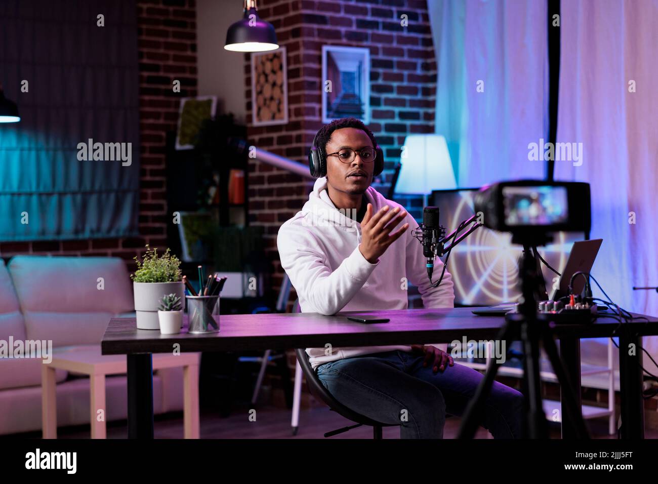 African american blogger recording live podcast vlog on camera, filming ...
