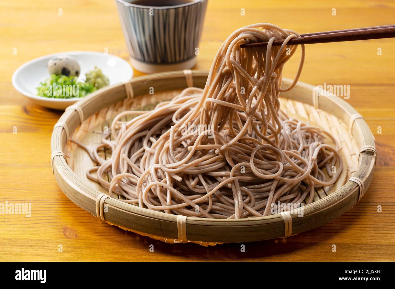 Zaru-soba and condiments on a wooden table. Take soba noodles with ...