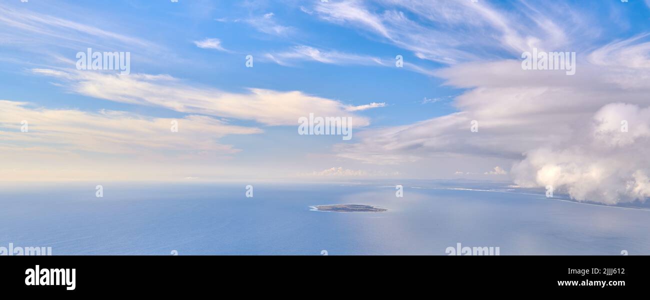 Beautiful, calm and quiet view of the ocean and clouds in blue sky with ...