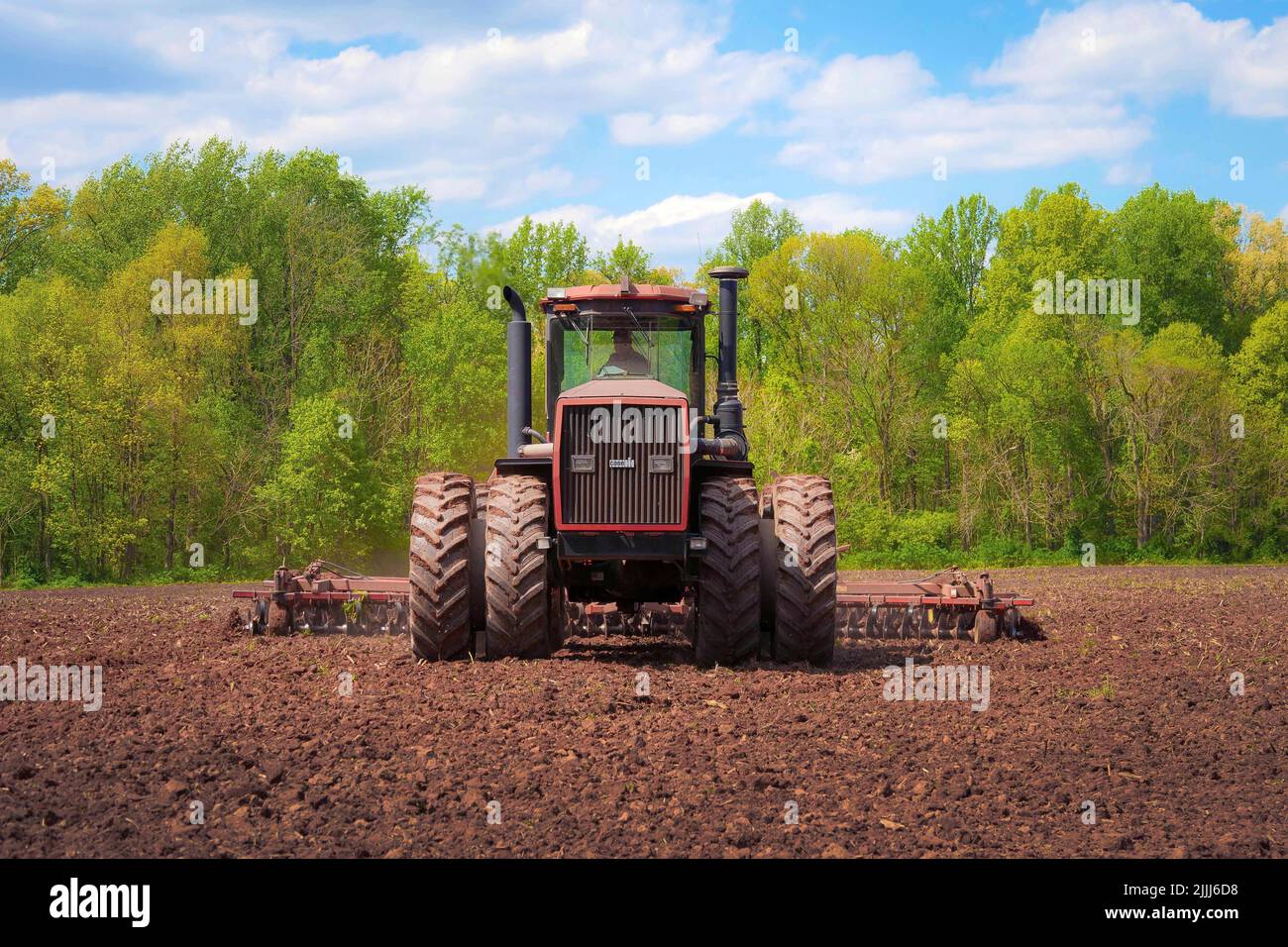 Farmer disking a field Stock Photo - Alamy