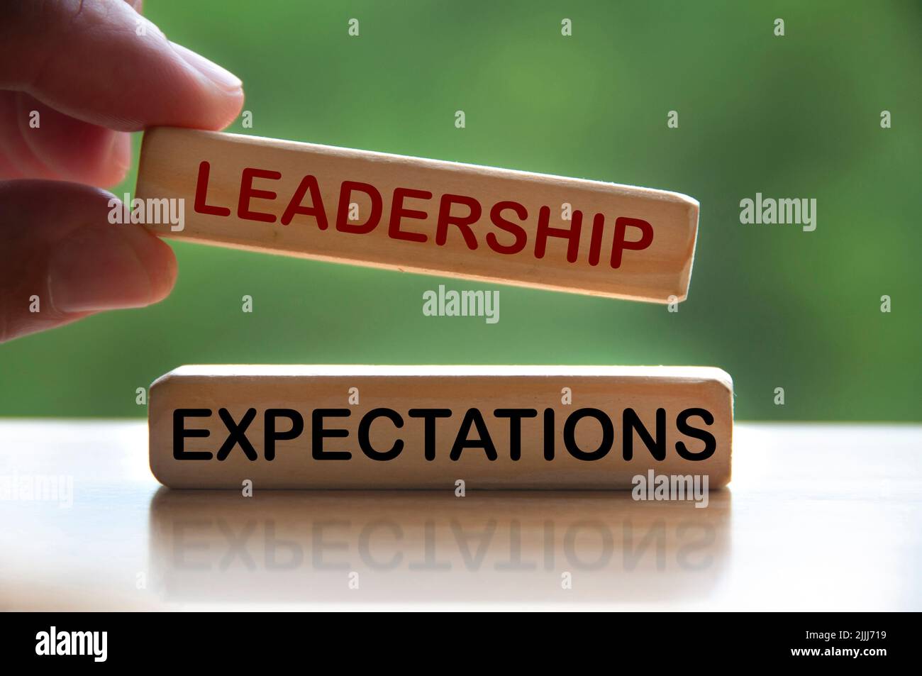 Hand holding wooden blocks with text - Leadership expectation ...