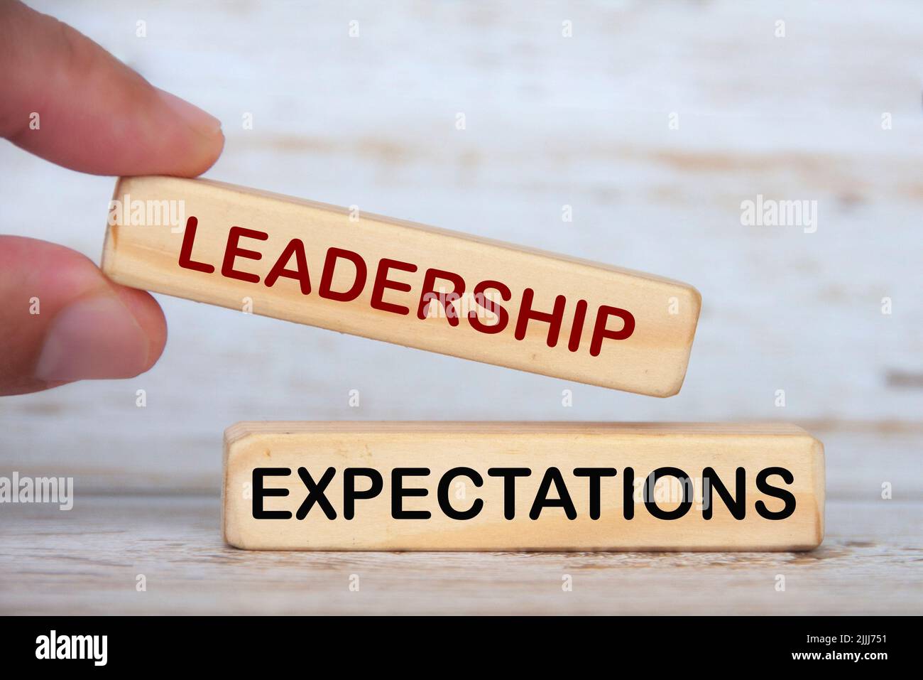 Hand holding wooden blocks with text - Leadership expectations ...