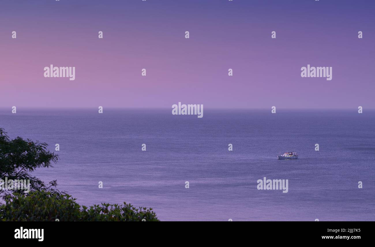 Beautiful sunset view of an open sea, purple sky and the horizon ...
