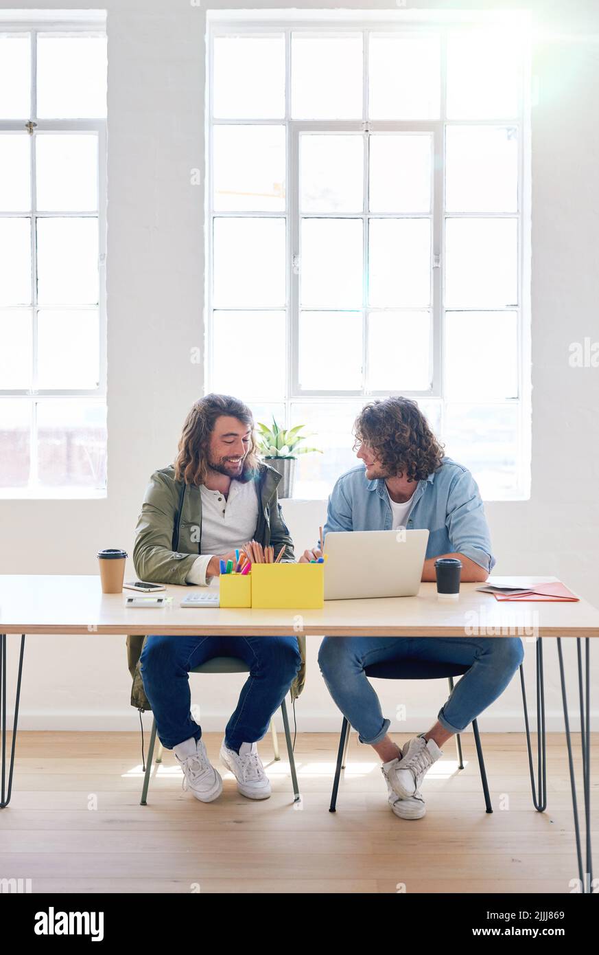 College students working together two young men brainstorming ideas for ...