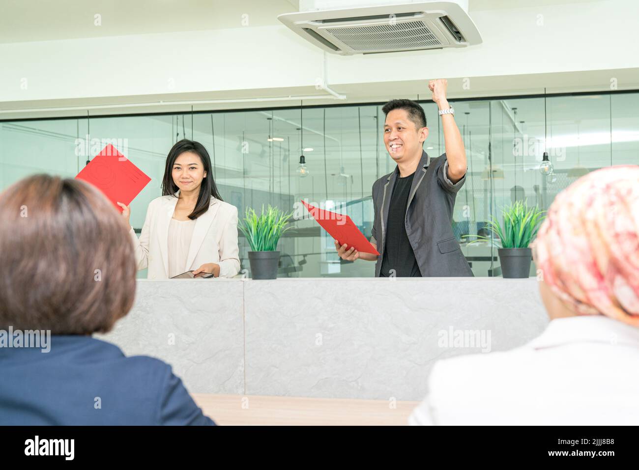 Businessman raising his hand and fist up in celebration during a ...