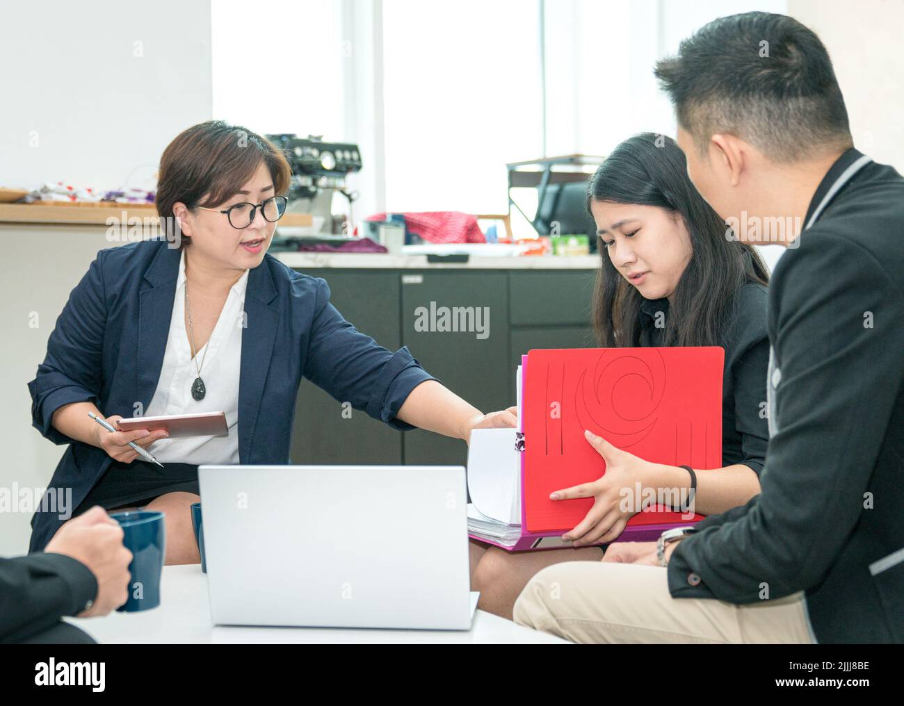 Business office colleagues discussing project over cup of coffee at the ...