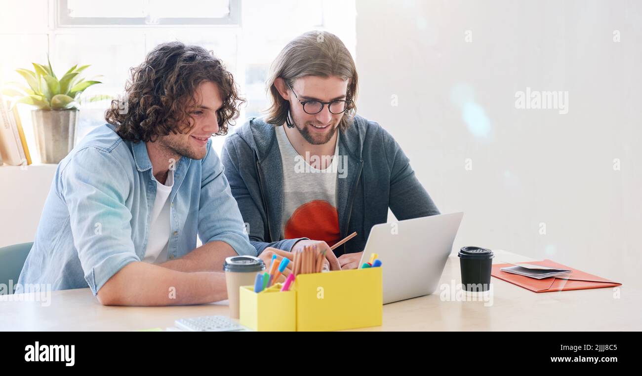 College students working together two young men brainstorming ideas for ...