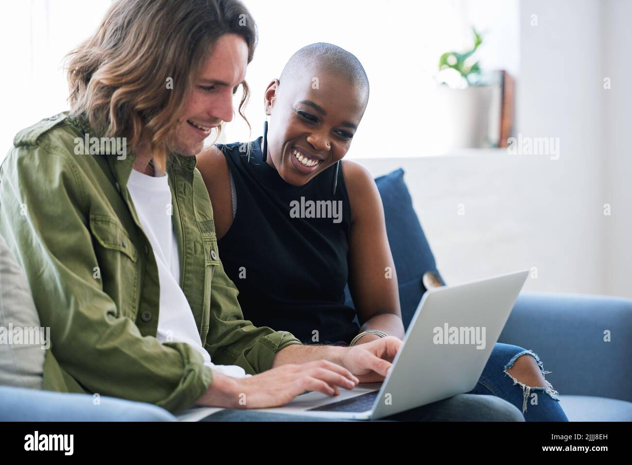 Watching laptop showing smiling hi-res stock photography and images - Alamy