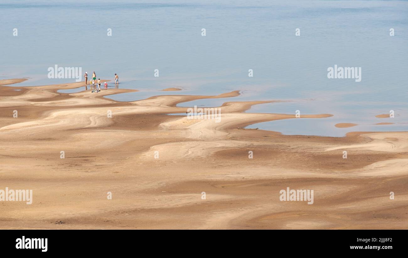 Summer minimal landscape, distant view of people enjoying the beach of ...
