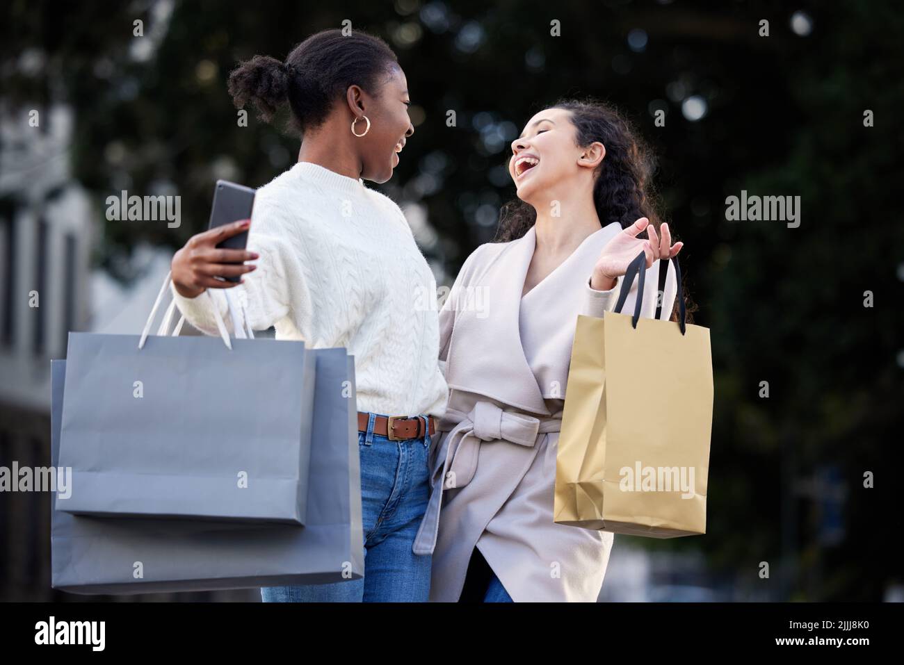 Its been far too long. two friends taking selfies while shopping ...