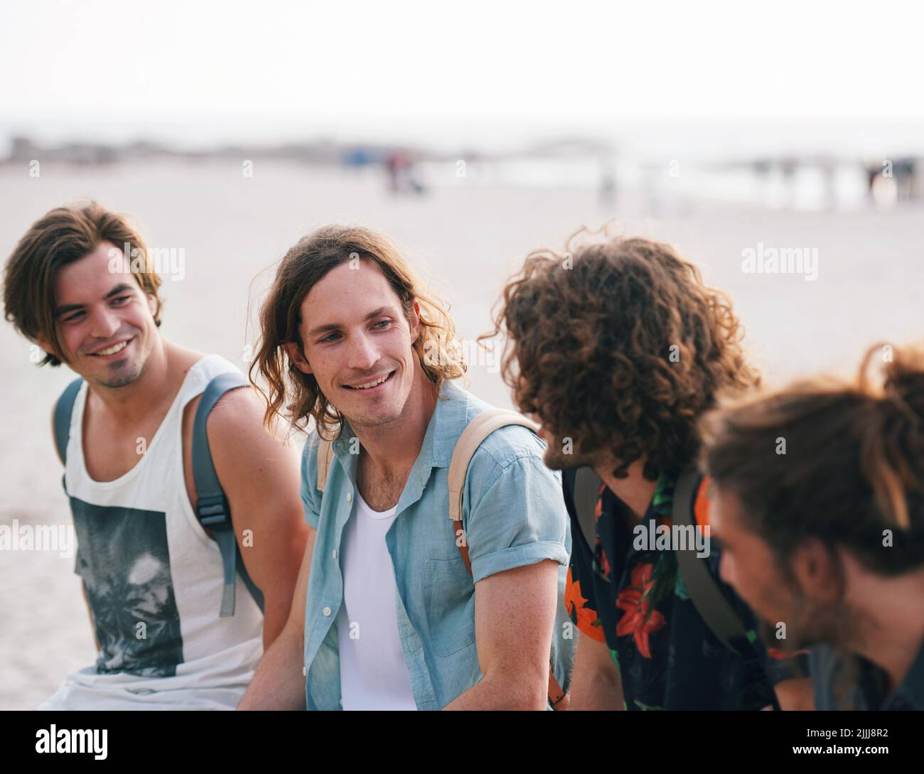 group of male friends on beach enjoying summer holiday students having ...