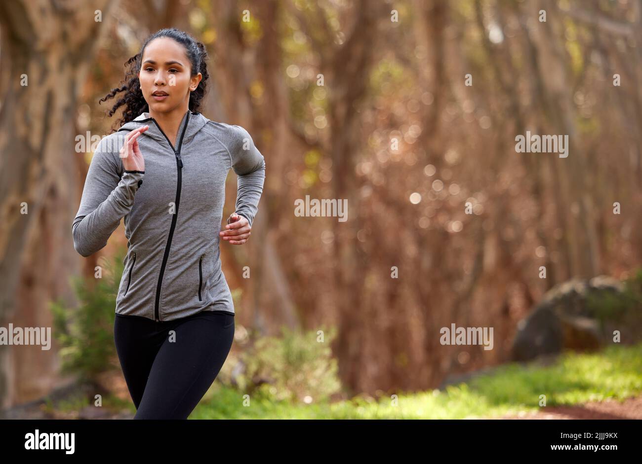 Good health is worth it. a fit young woman out for a run Stock Photo ...