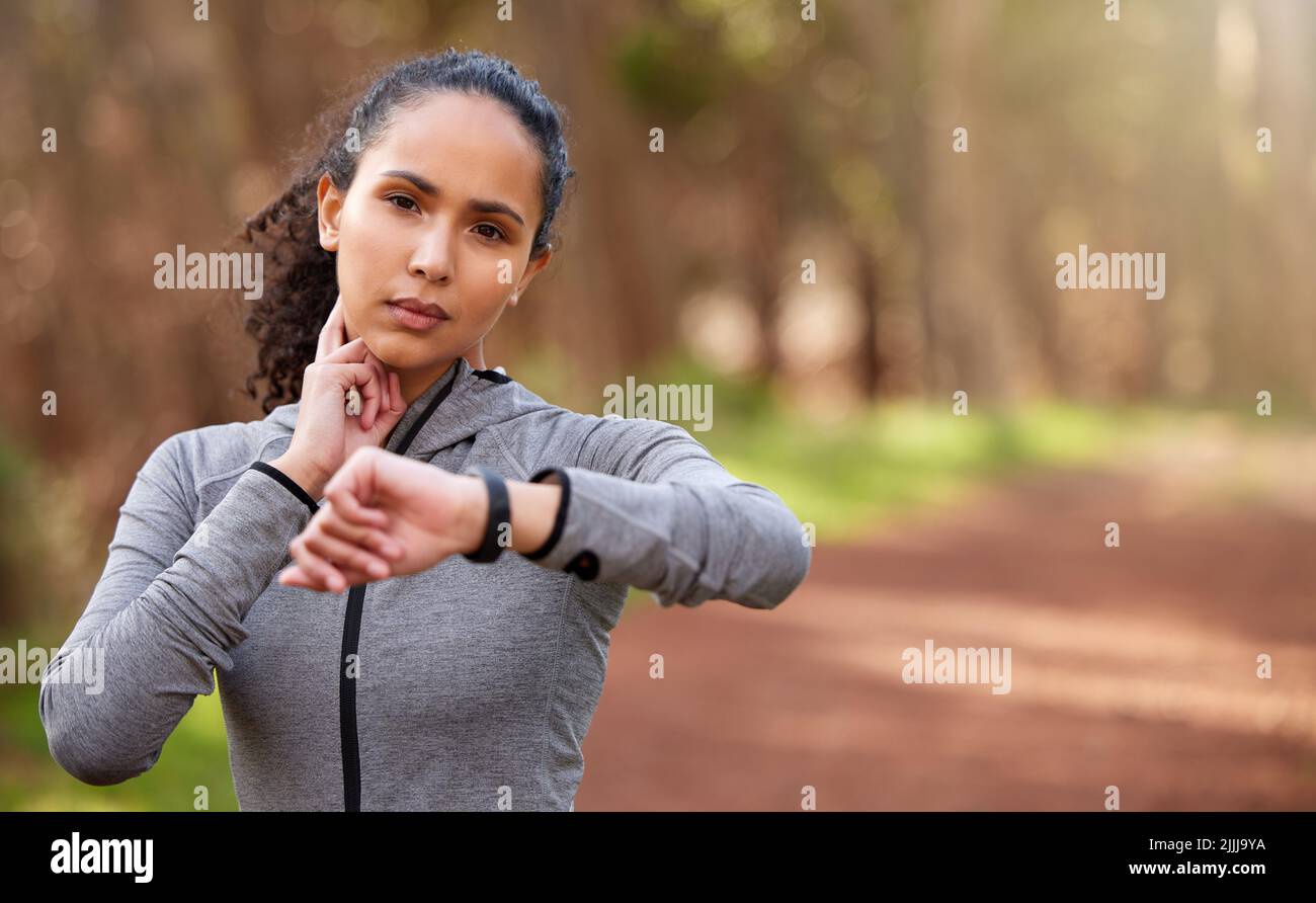 Check your pulse. a woman feeling her pulse while checking her watch ...