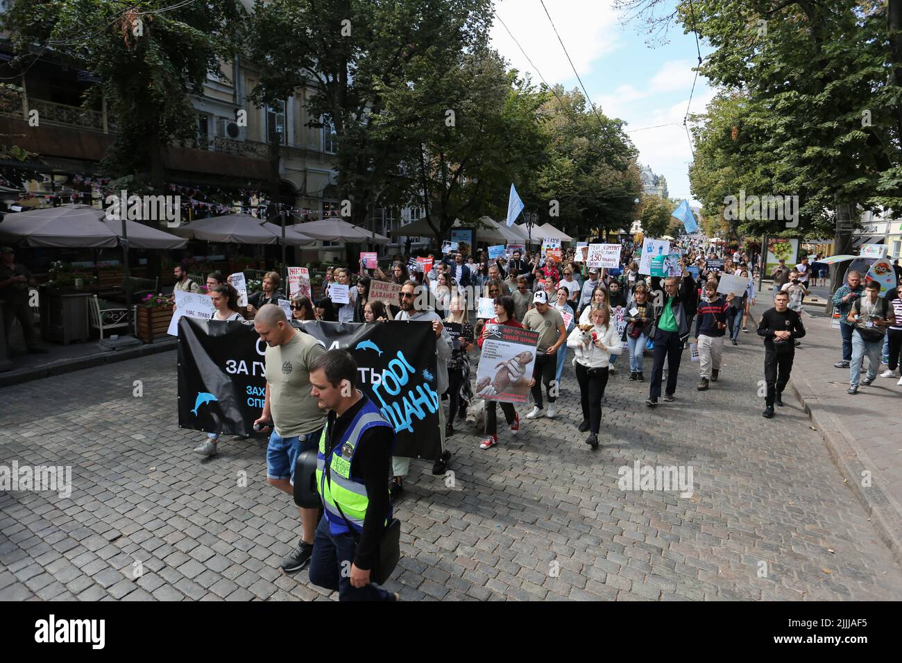 Participants march with placards expressing their opinion along ...