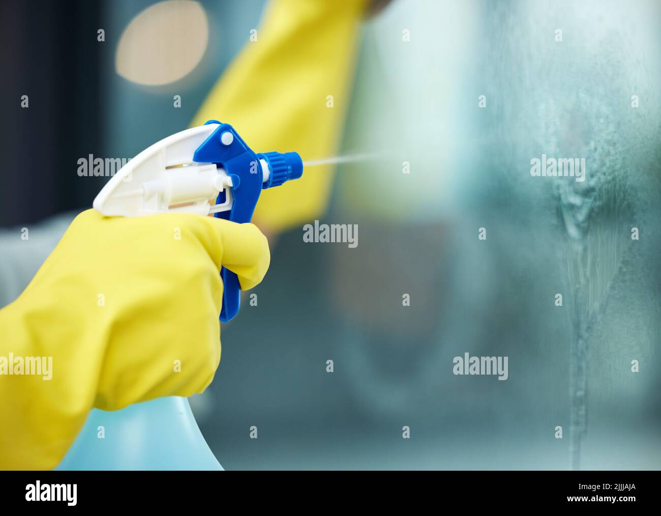 This all purpose cleaner works wonders. a woman wearing gloves while ...