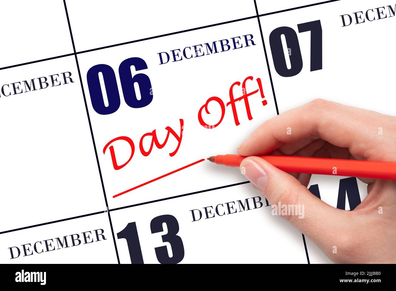 6th day of December. Hand writing text DAY OFF and drawing a line on ...