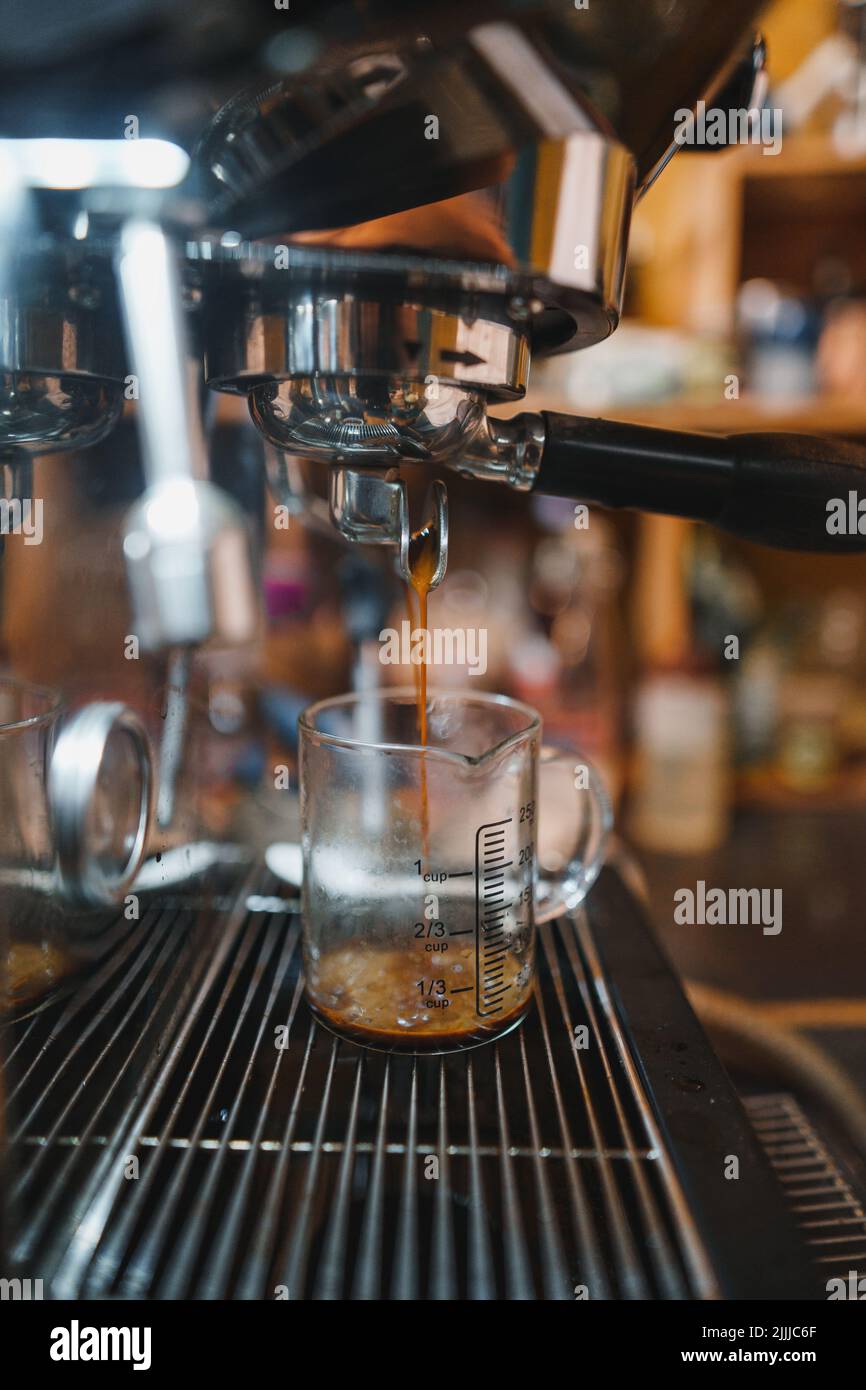 Expresso coffee dripping from the machine,black coffee Stock Photo - Alamy