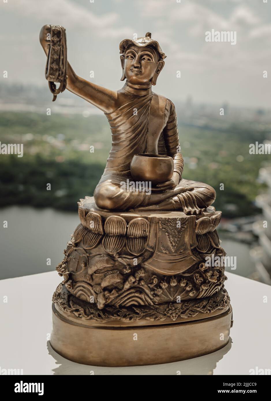 Bronze figurine of Phra upagupta or Phra bua khem statue with nature ...