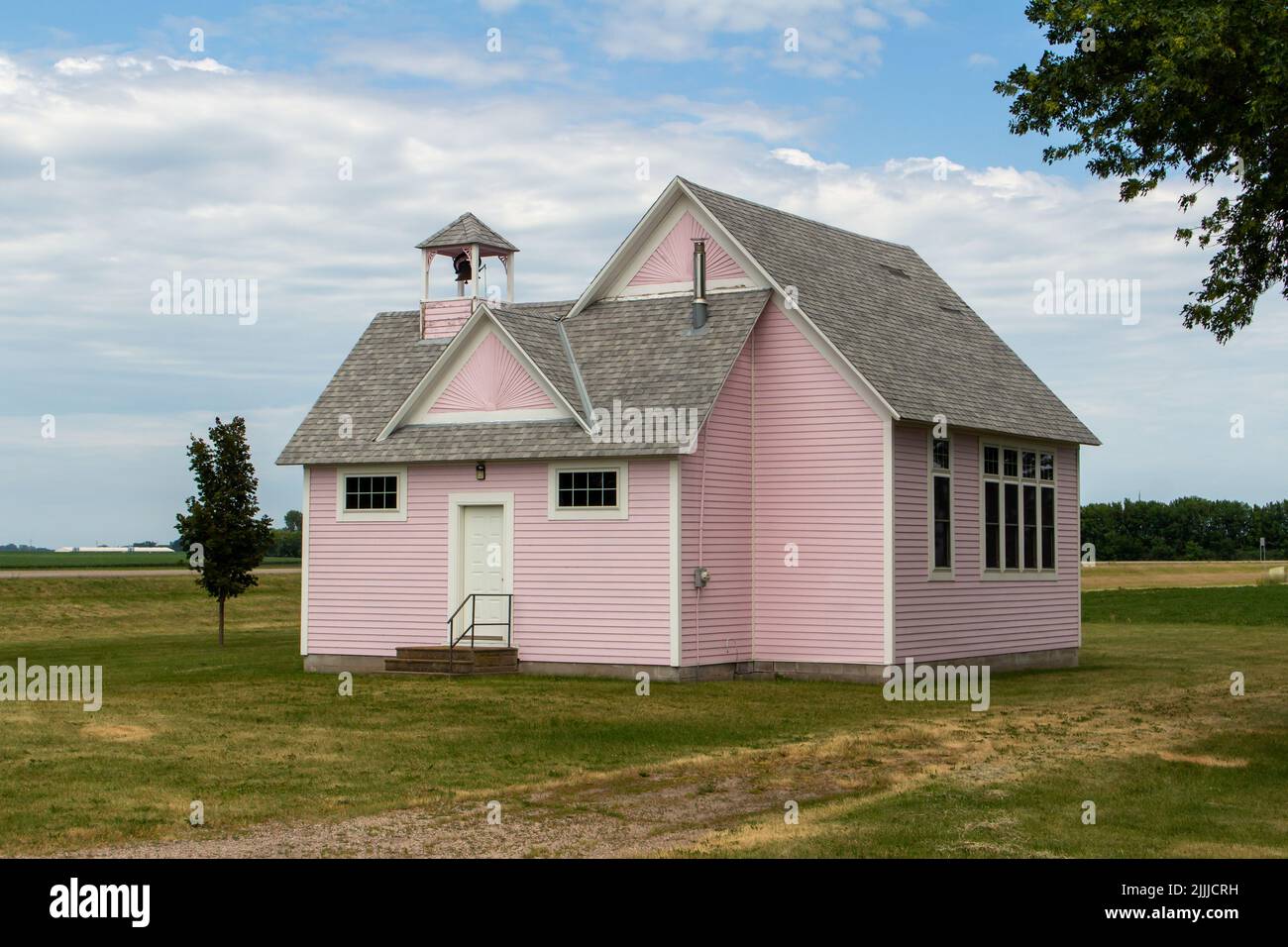 Landscape view of an old historic pink country school house exterior ...