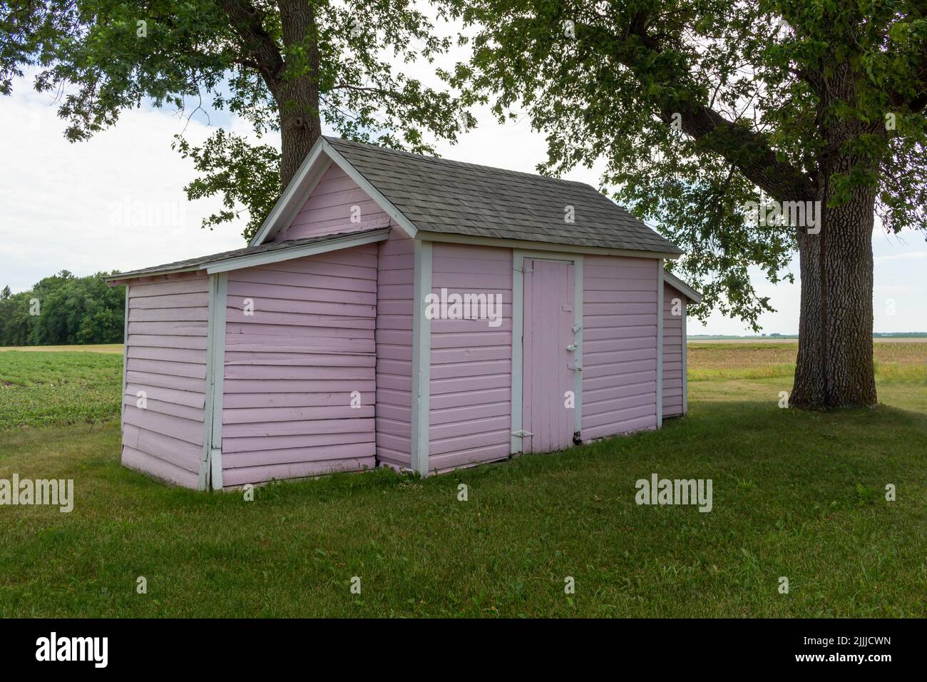 Landscape view of an old historic pink country school house exterior ...