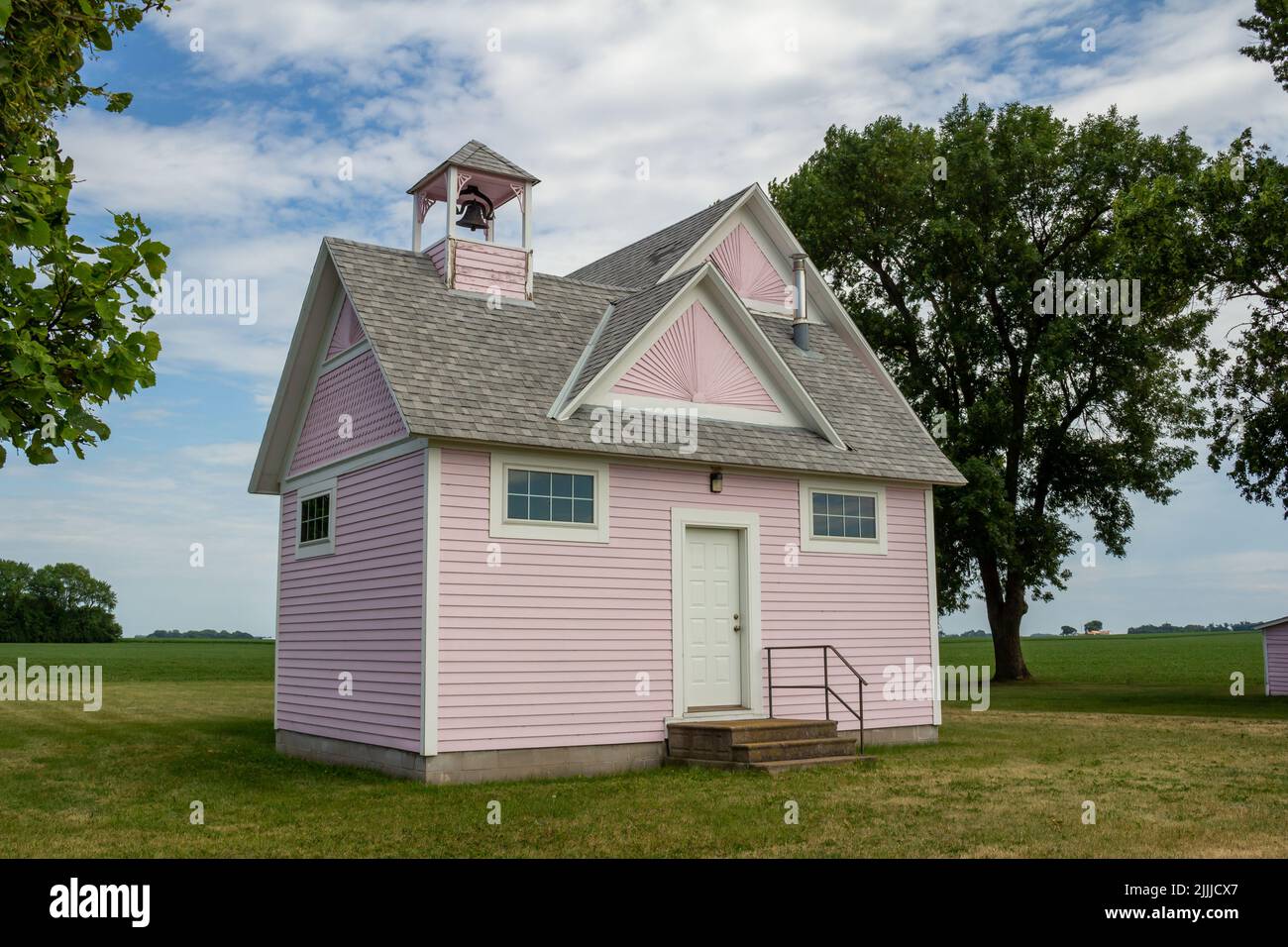 Landscape view of an old historic pink country school house exterior ...