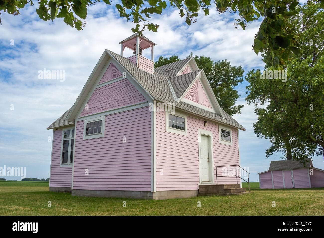 Landscape view of an old historic pink country school house exterior ...