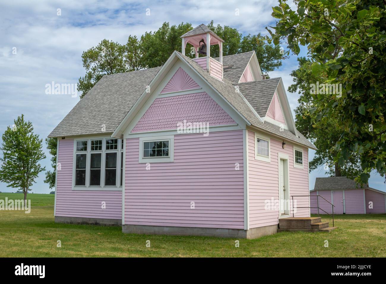 Landscape view of an old historic pink country school house exterior ...