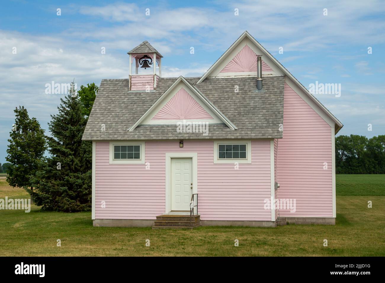 Landscape view of an old historic pink country school house exterior ...