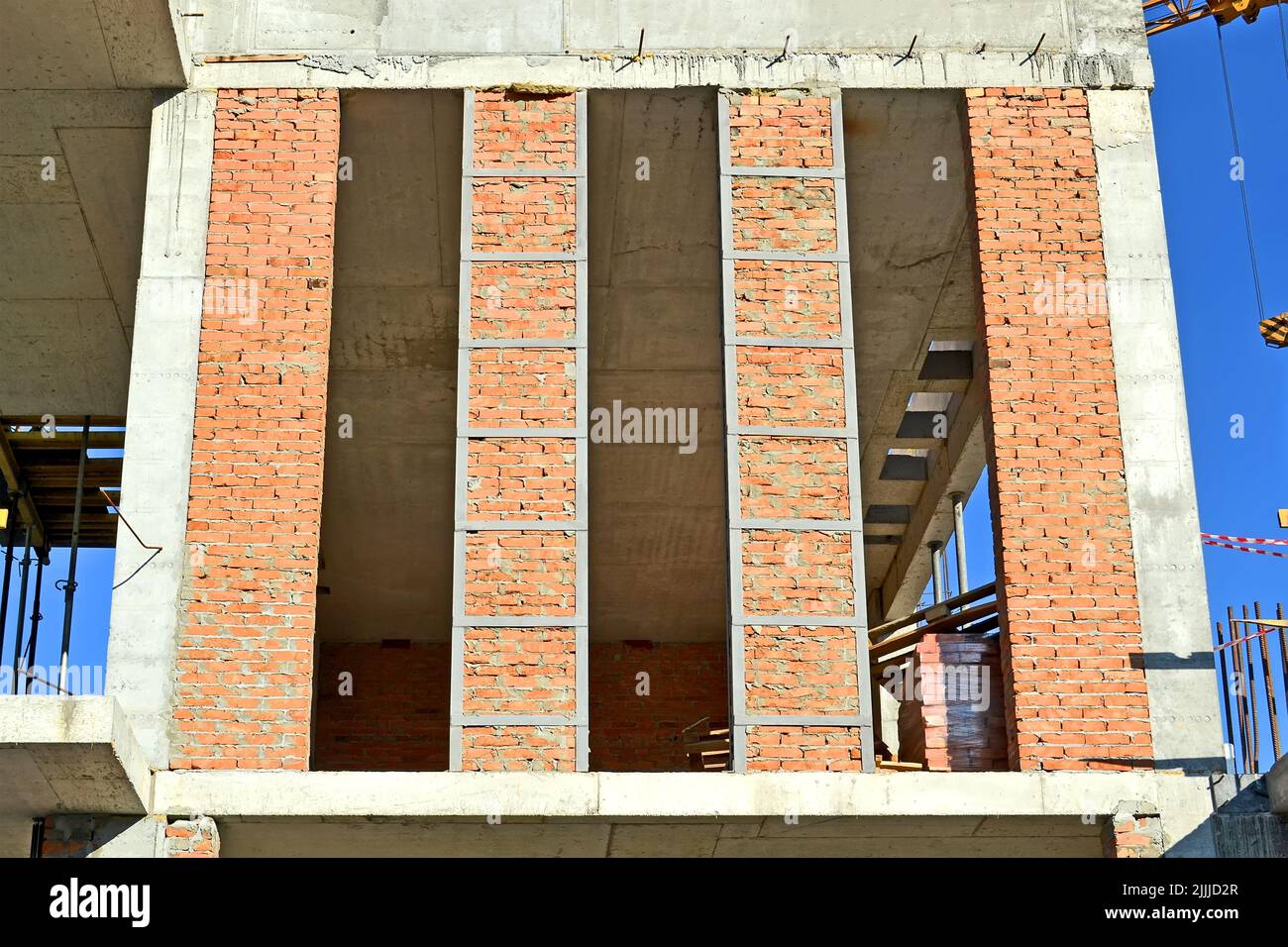 red brick column wall in sunny day, modern building site diversity ...