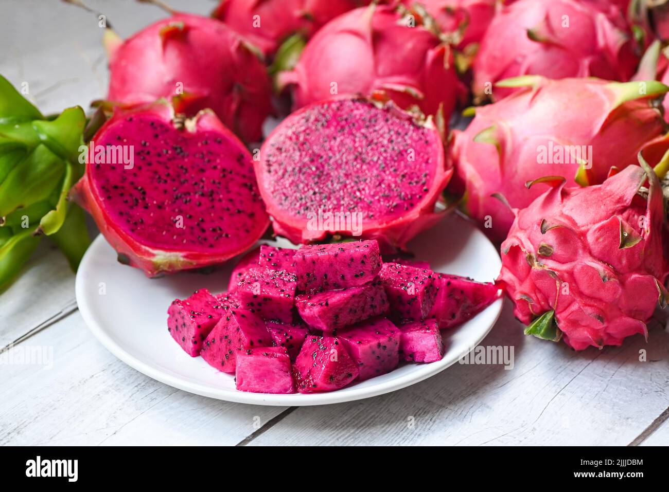 dragon fruit slice and cut half on white plate with pitahaya background ...
