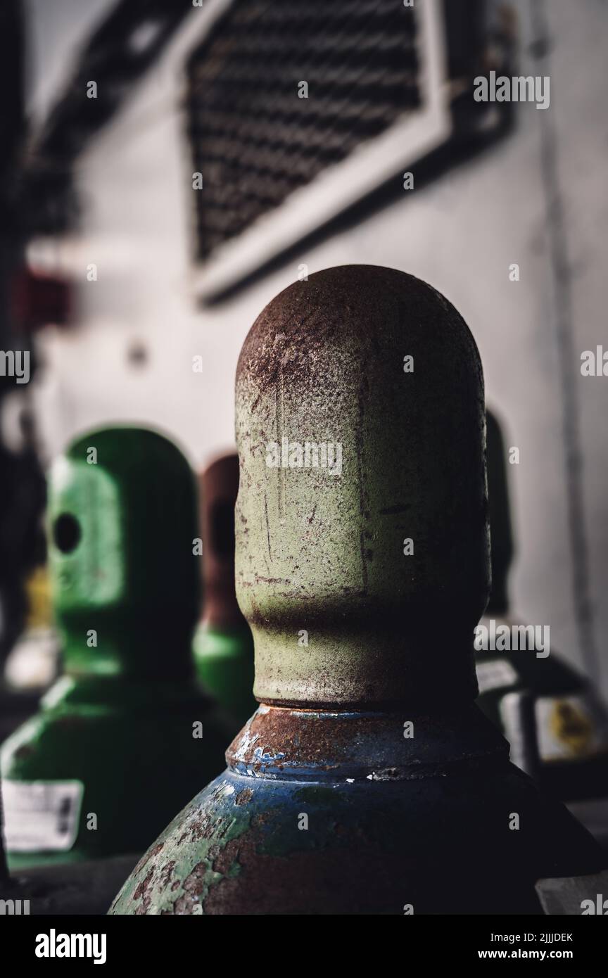 Compressed gas cylinders being stored vertically secured by a metal ...