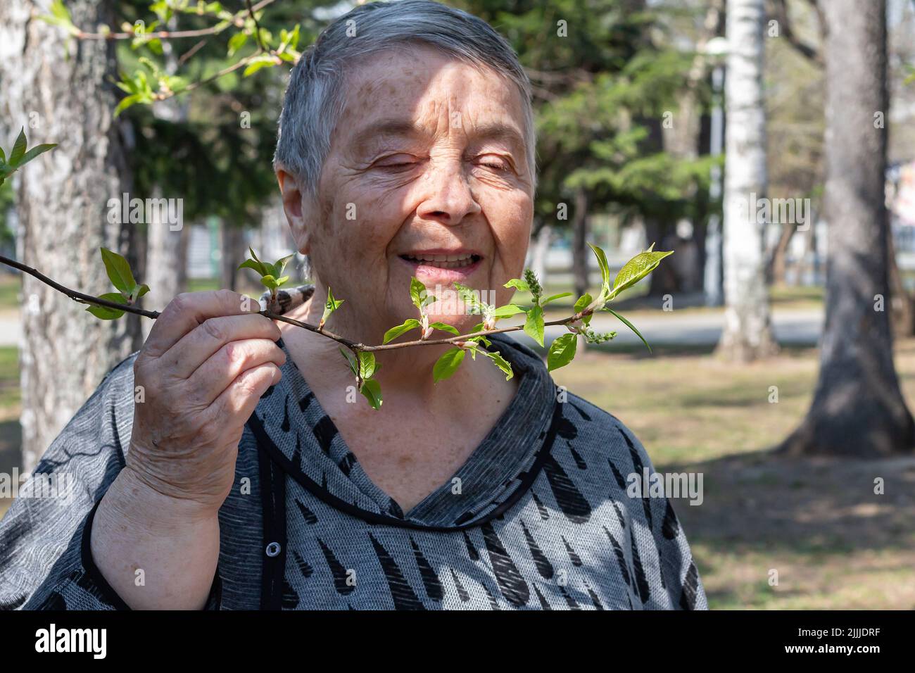 Close-up Portrait of stylish emotional model near flowering tree ...
