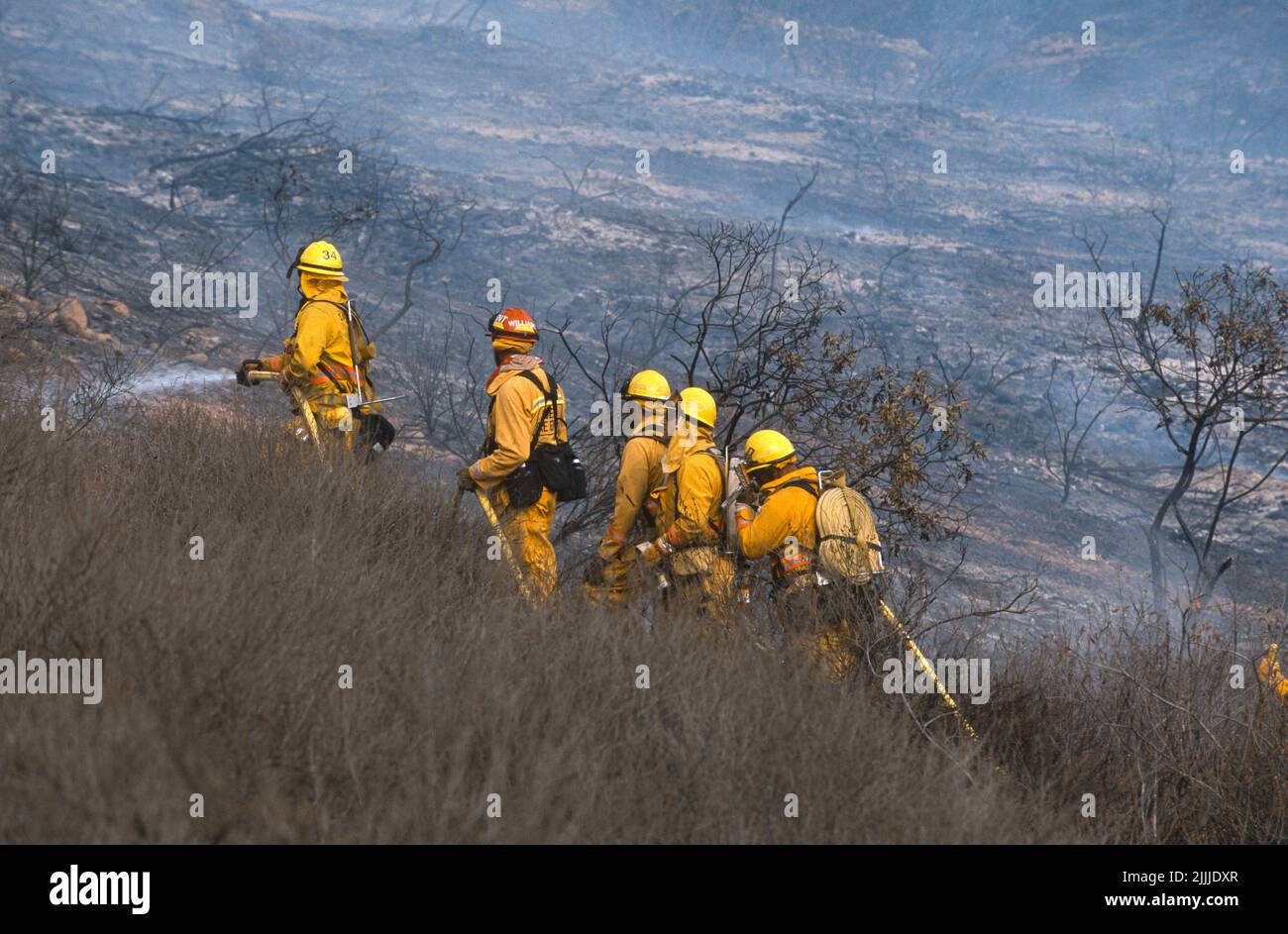 Firefighters working the flank of a fire in San Diego, California Stock ...